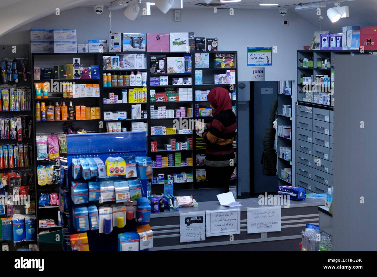 A Palestinian pharmacist in a pharmacy in the Muslim quarter old city ...