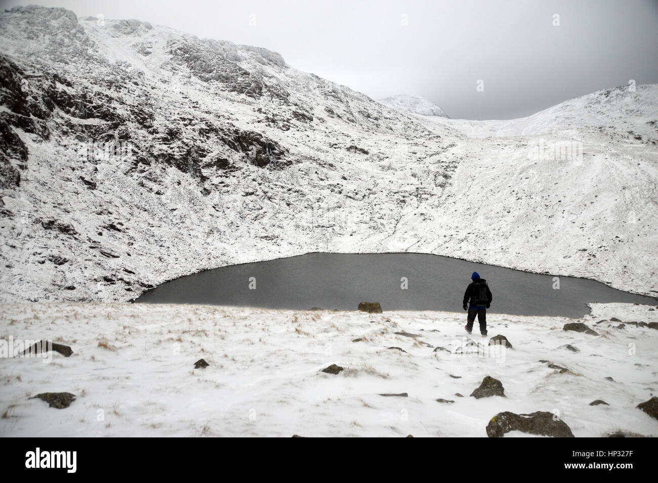 A Lone Male Walker Heading Towards Angle Tarn and Esk Hause in Snow ...
