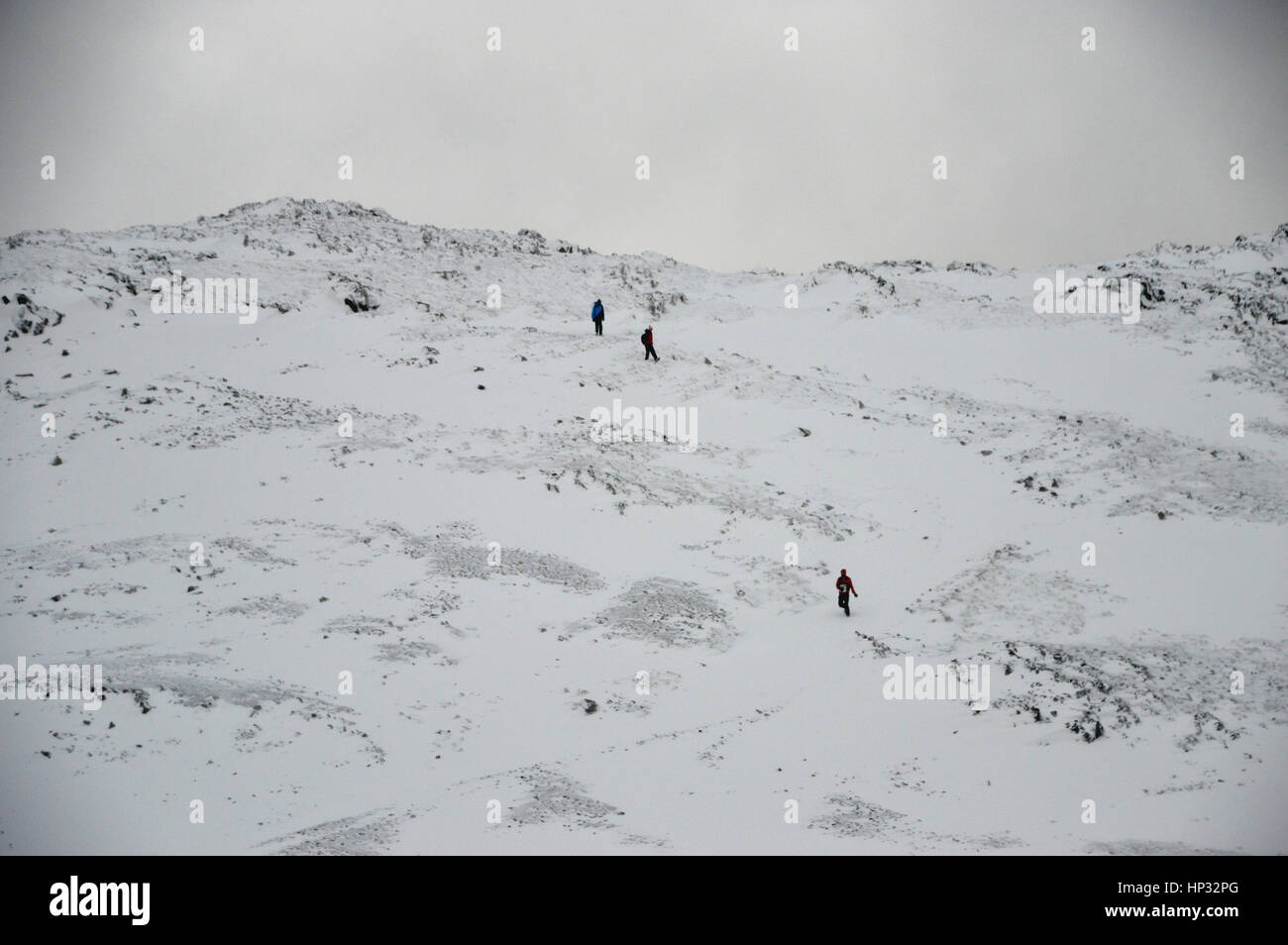 Three Winter Hikers Walking down to Esk Hause in Snow from the ...