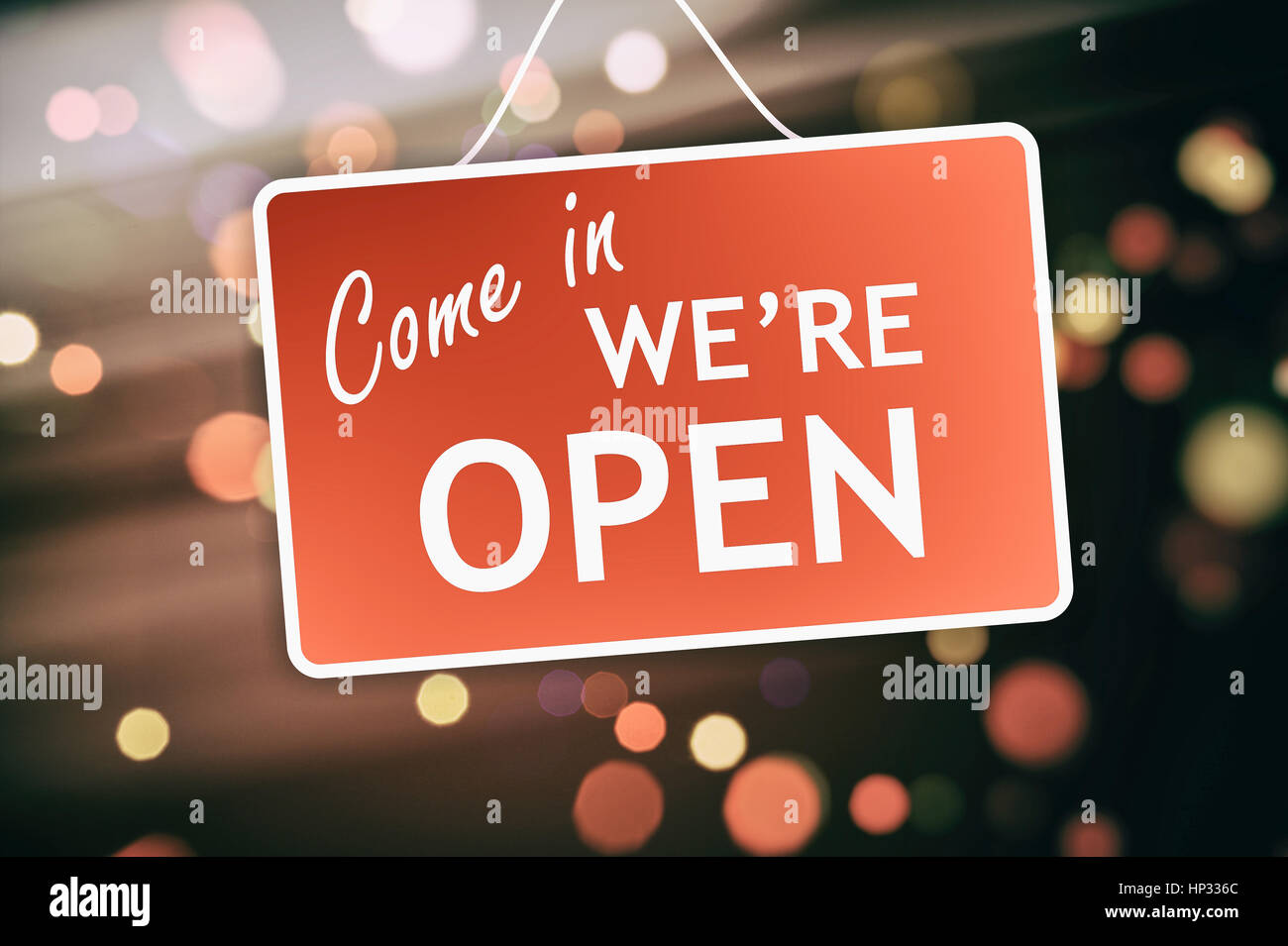We are open sign hanging on a glass storefront Stock Photo - Alamy