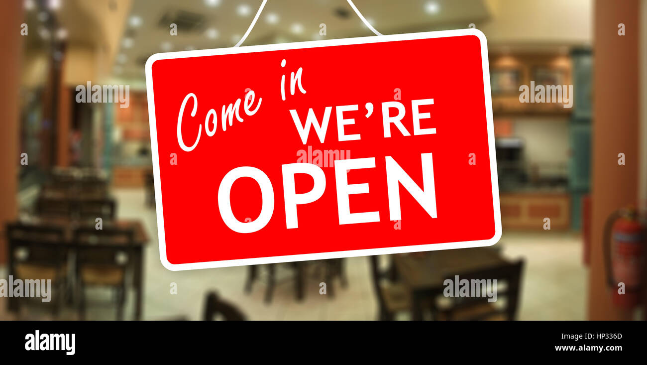 We are open sign hanging on a glass storefront Stock Photo - Alamy