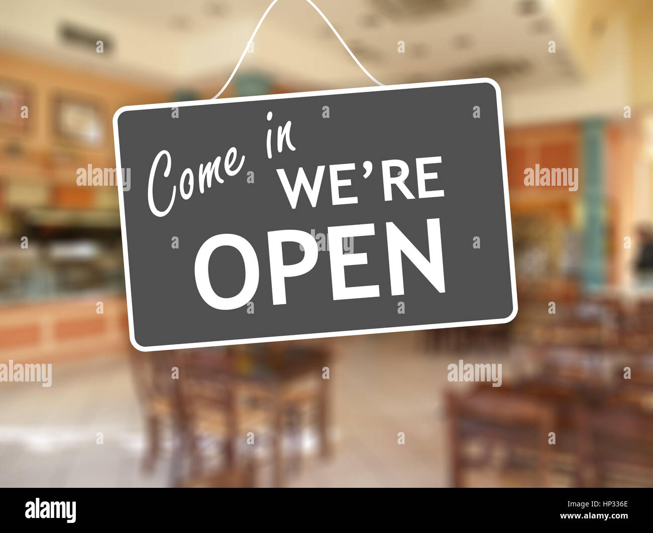 We are open sign hanging on a glass storefront Stock Photo - Alamy