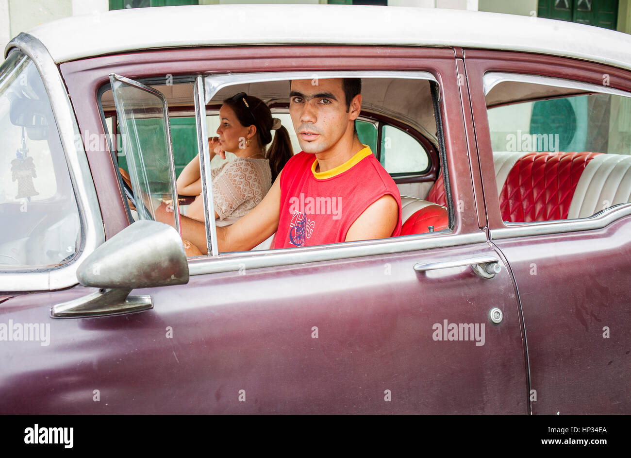 Taxicab, vintage car, driver and client, Street scene in Old Havana ...