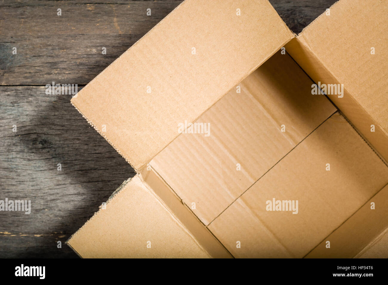 open square cardboard box on the background of the old wooden table ...
