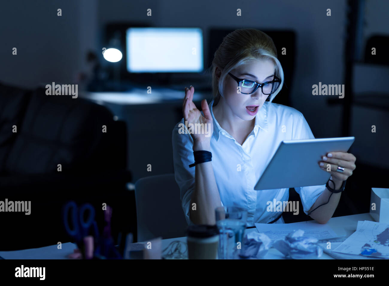 Surprised female programmer using tablet in the office Stock Photo - Alamy