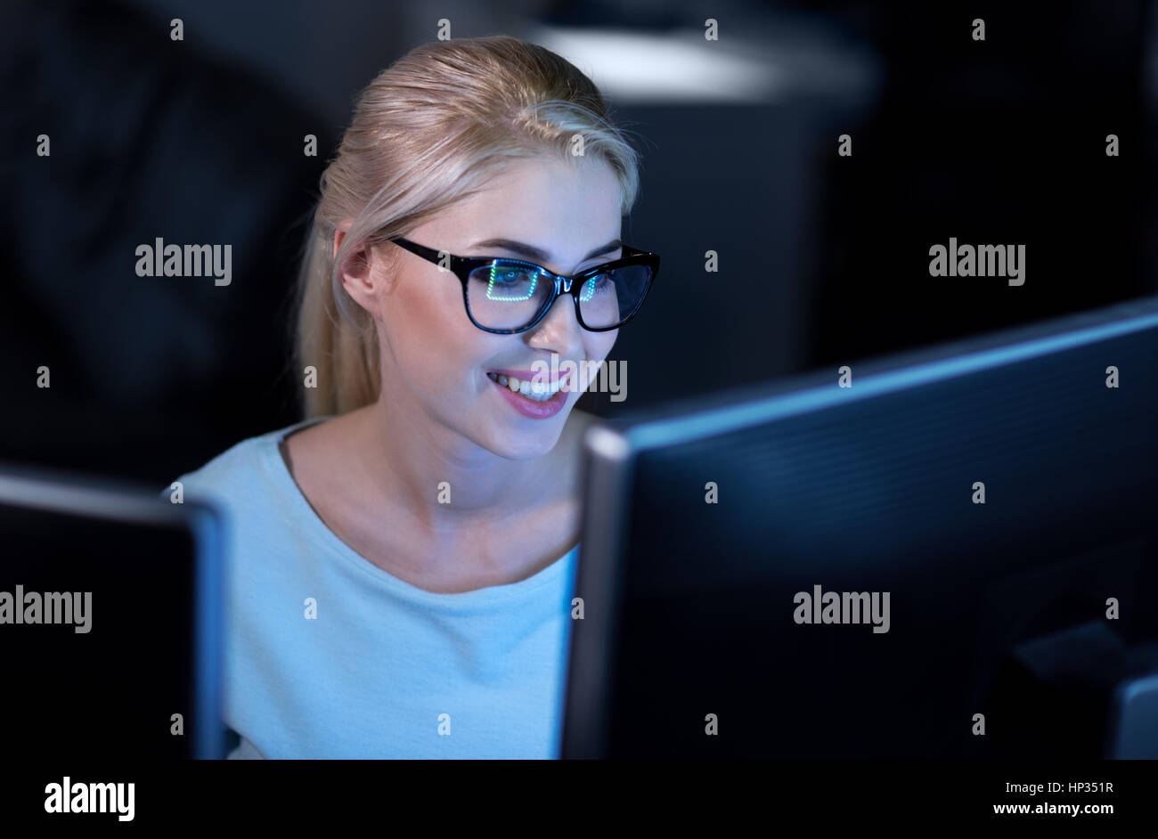 Smiling female programmer decoding codes at work Stock Photo - Alamy