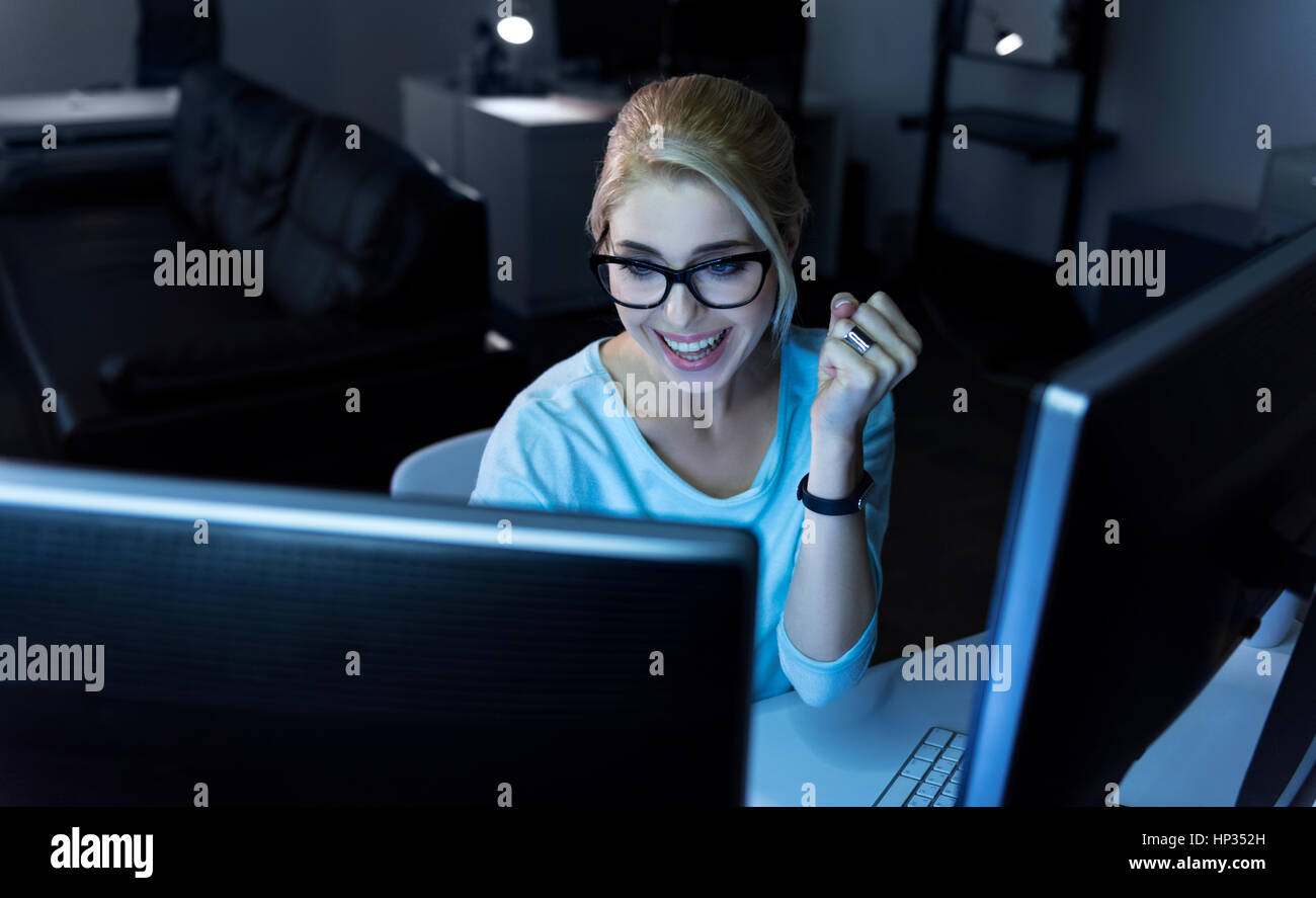 Delighted female programmer having successful results in the office ...