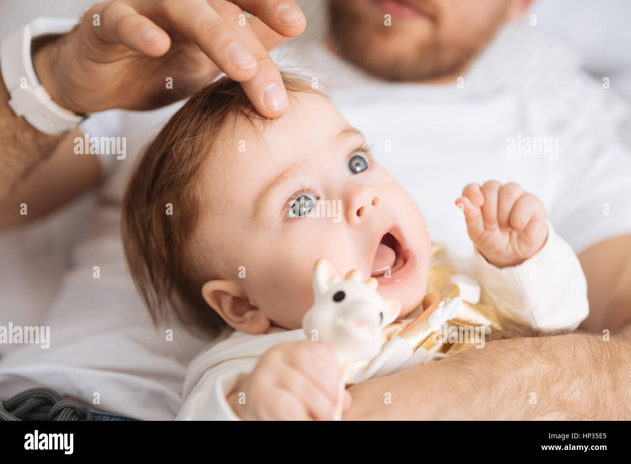 Amused little kid playing games with her father at home Stock Photo - Alamy