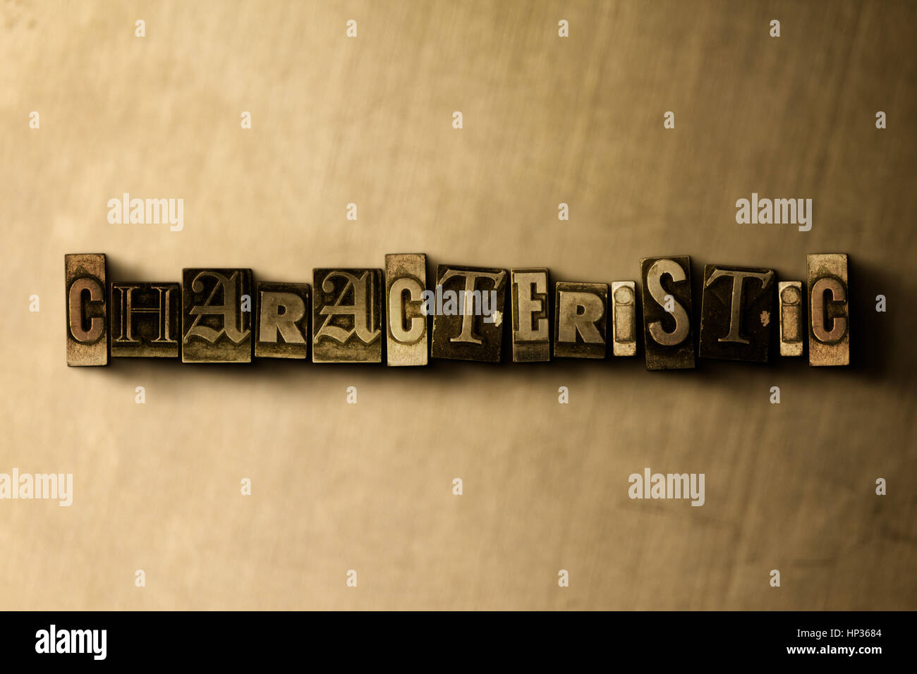 CHARACTERISTIC - close-up of grungy vintage typeset word on metal ...