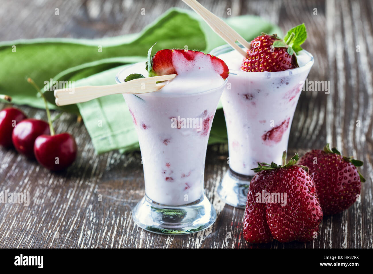 Frozen fruit smoothies with fresh strawberries on top served in chilled ...