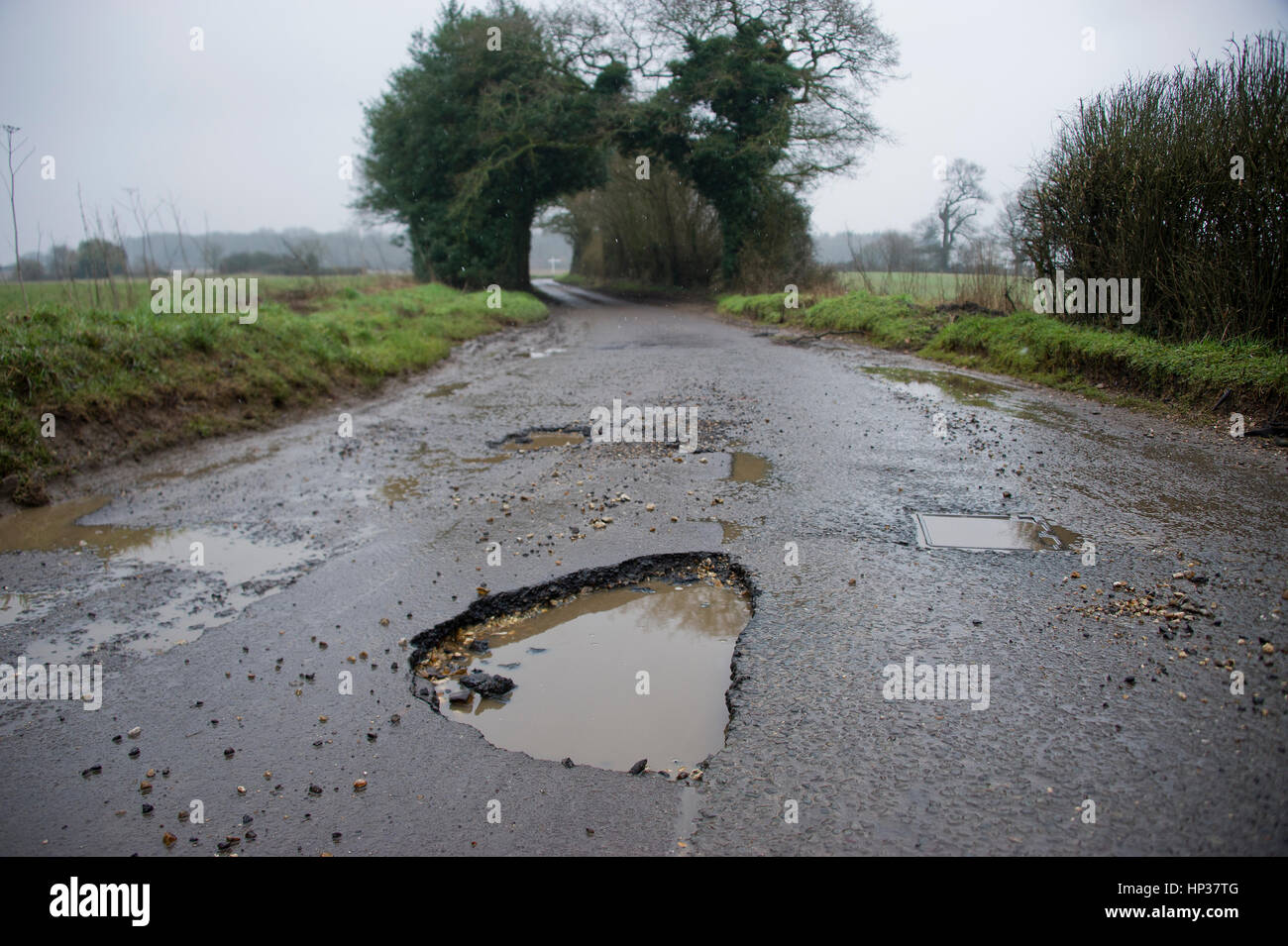 Potholes on a public road in the UK Stock Photo - Alamy