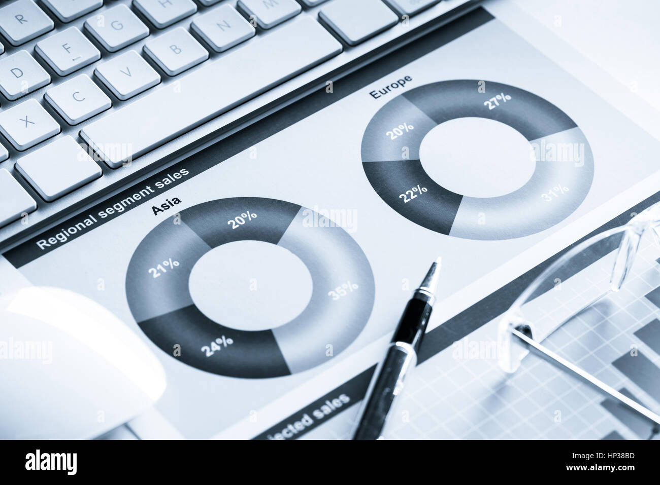 Business workplace with keyboard mouse and papers with graphs and ...