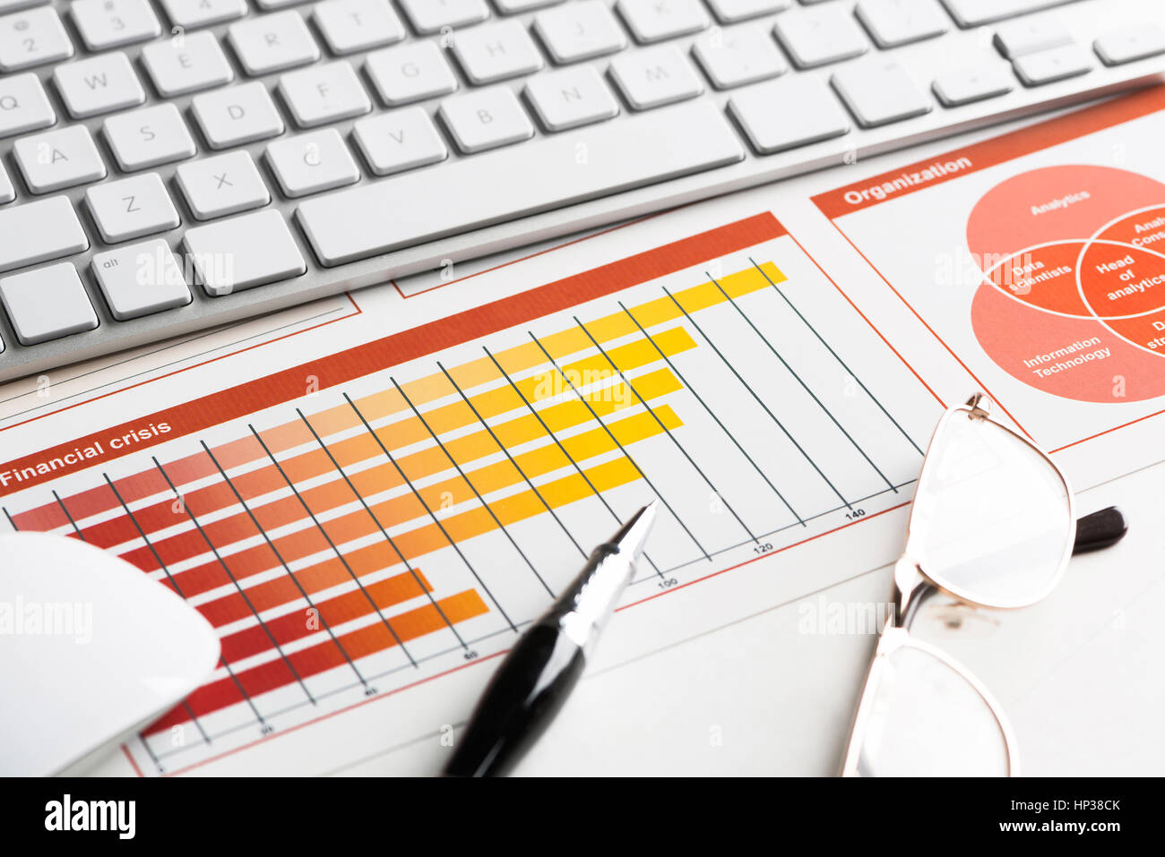 Business workplace with keyboard mouse and papers with graphs and ...