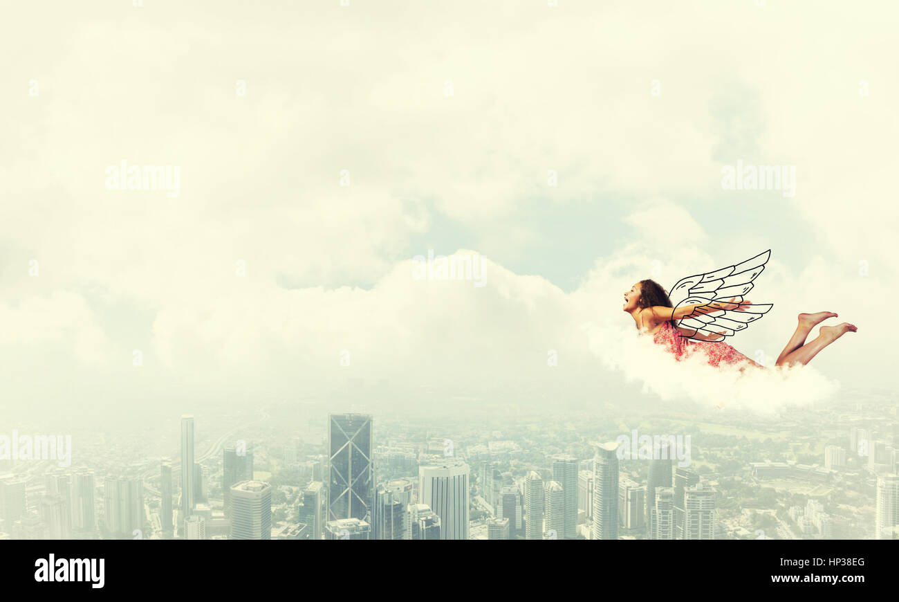 Young woman flying high in blue sky Stock Photo - Alamy