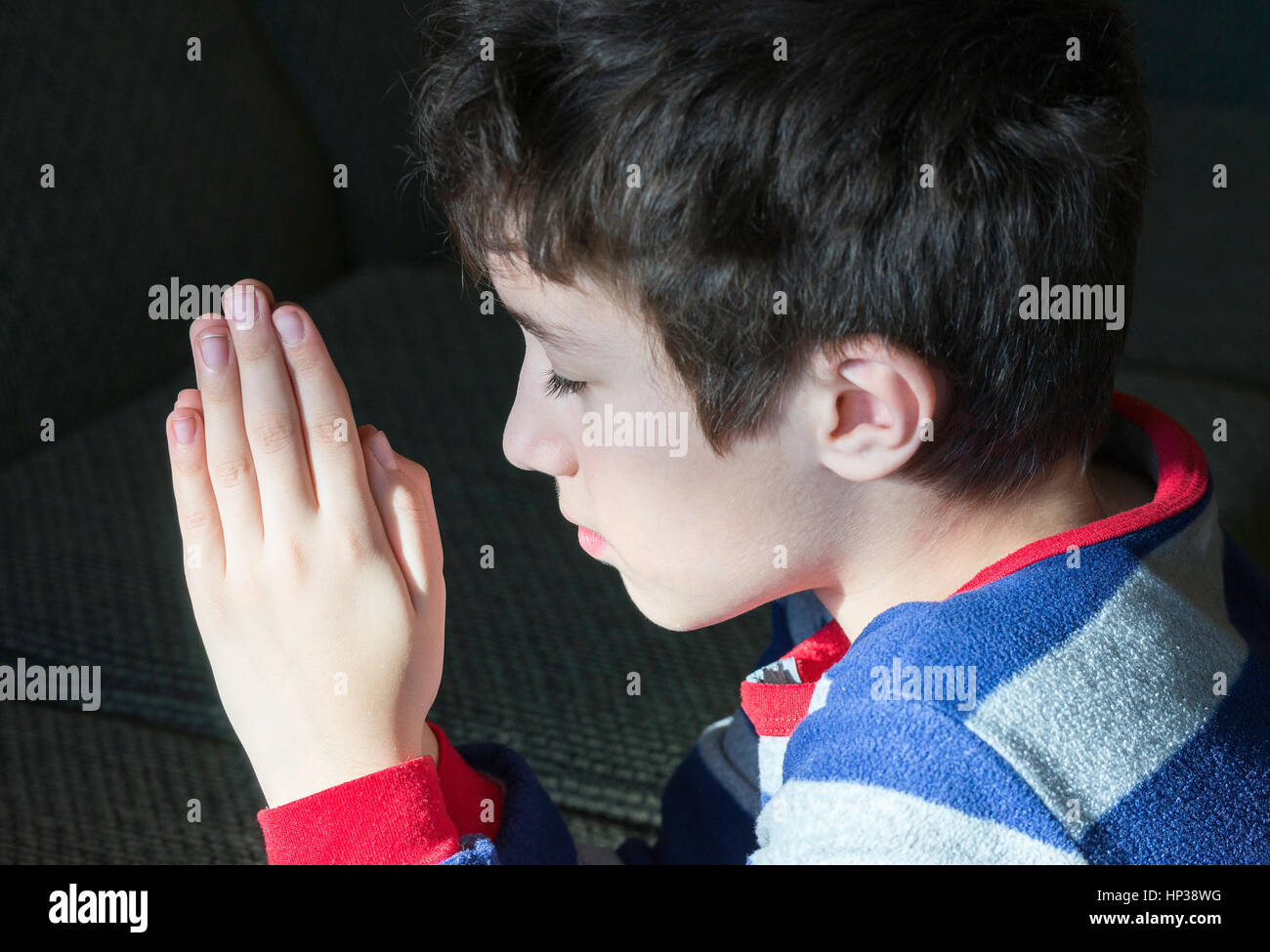 Young boy praying with innocent faith to his God, Christian religious ...
