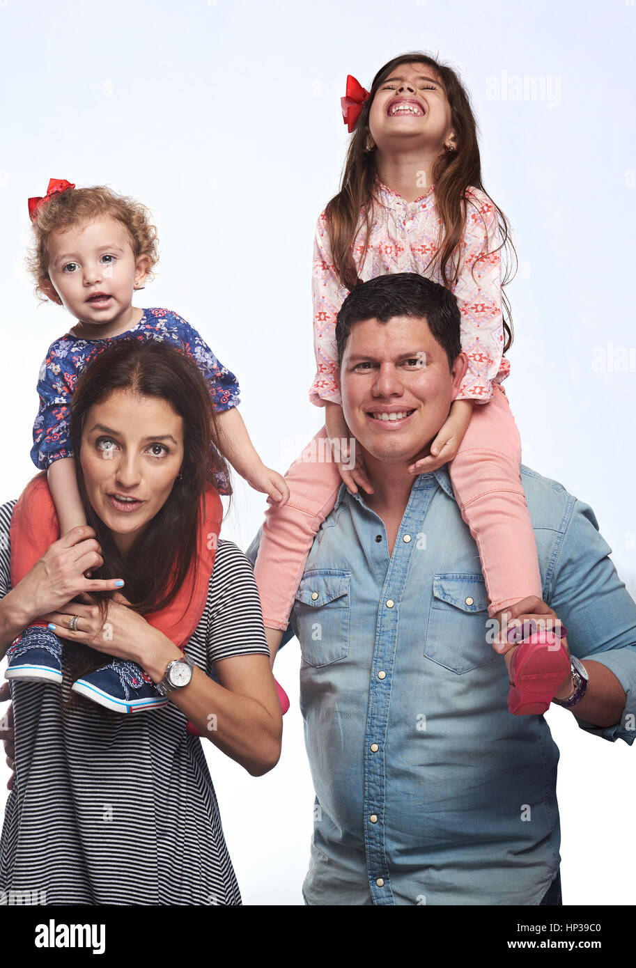 Young couple with kids girls isolated on white background Stock Photo ...