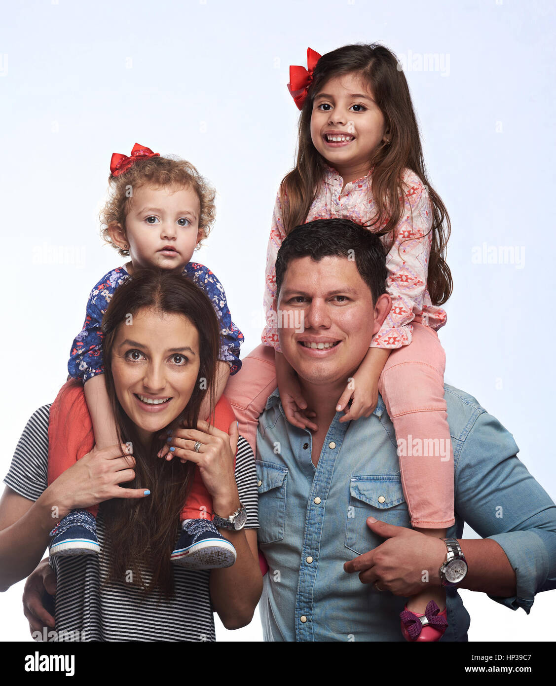 Portrait of happy family with two girls on shoulders isolated on white ...