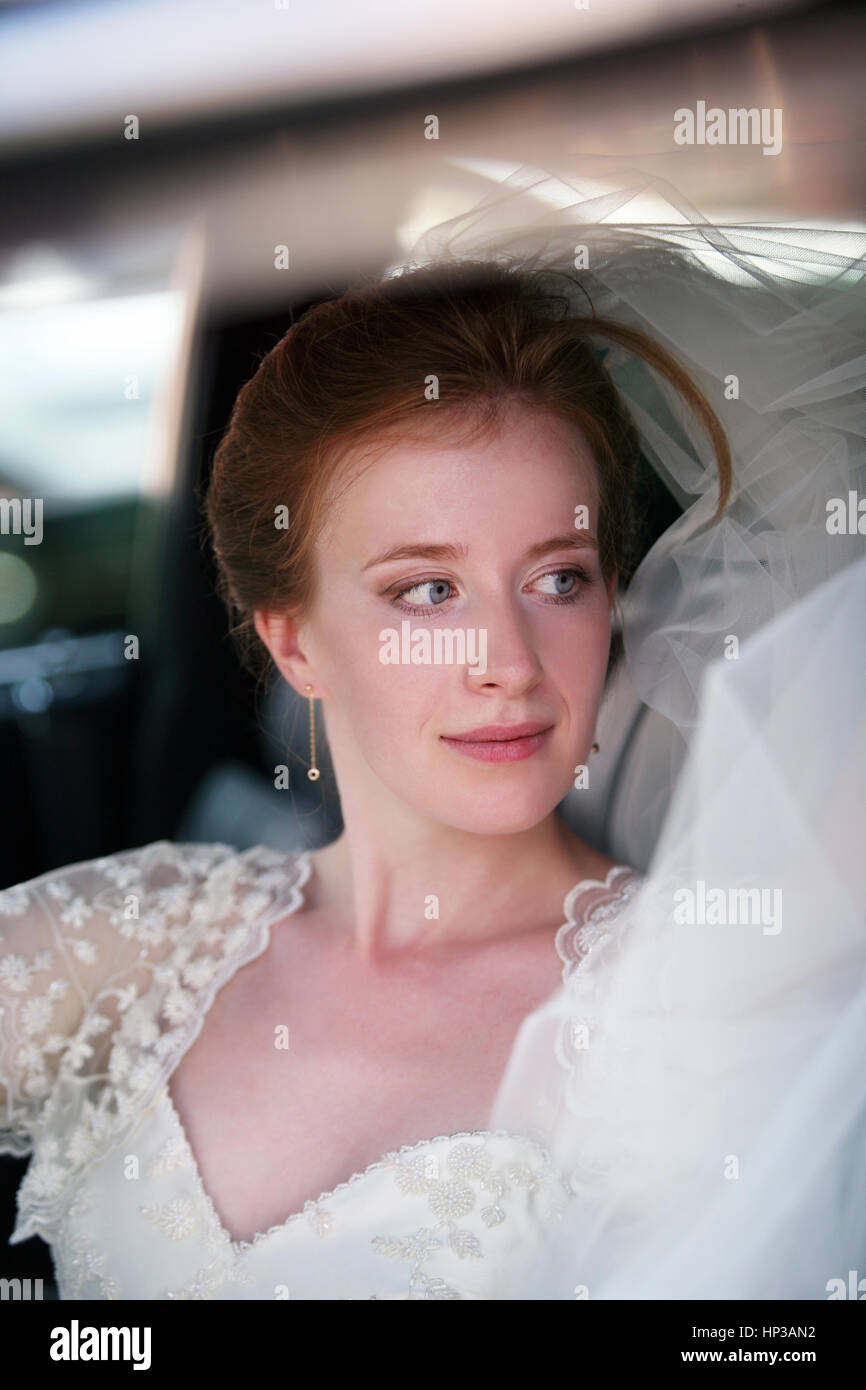 Portrait of a beautiful bride in a car Stock Photo - Alamy