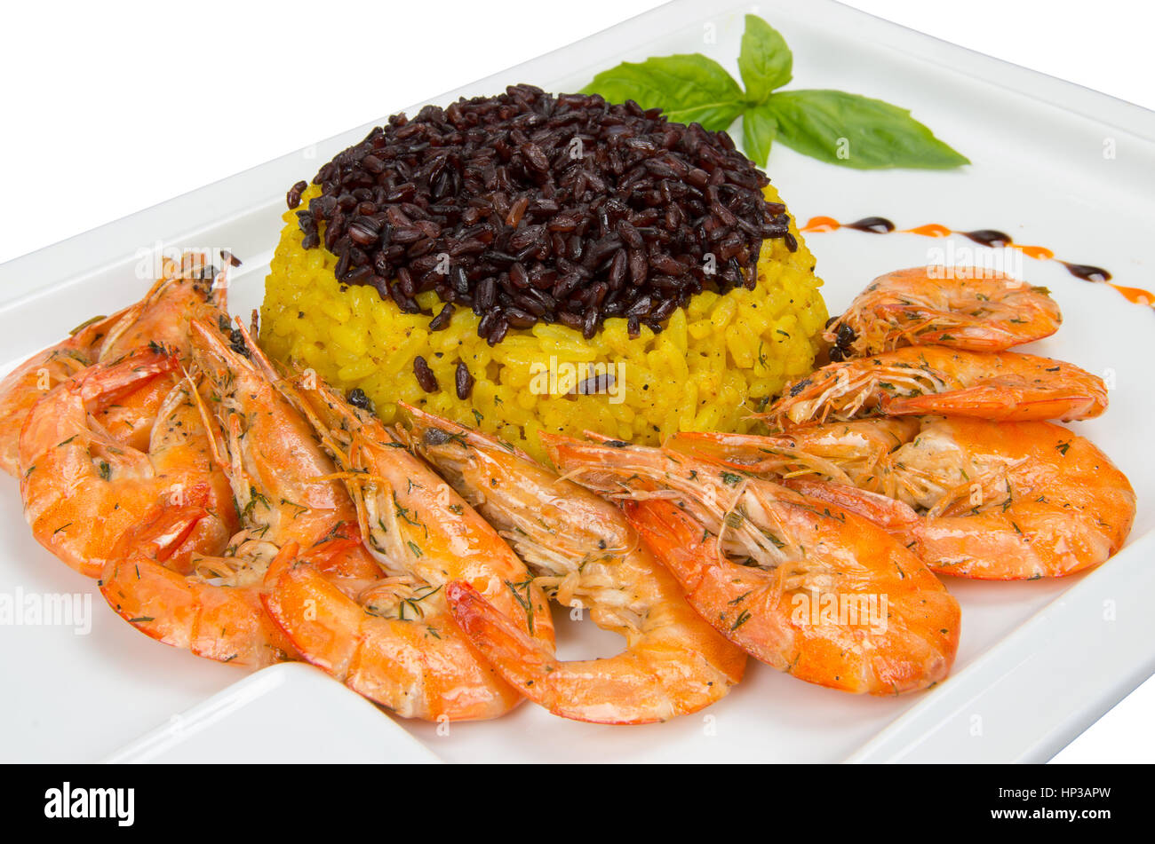Sea gift. Shrimp with yellow rice and black Stock Photo - Alamy