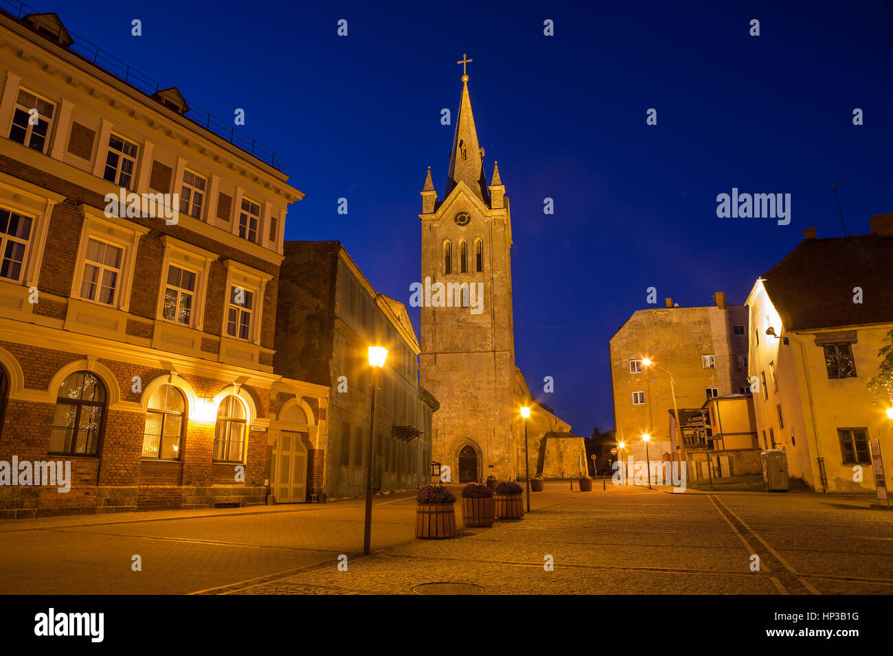 Medieval church of Saint John and night old town view of Cesis, Latvia ...