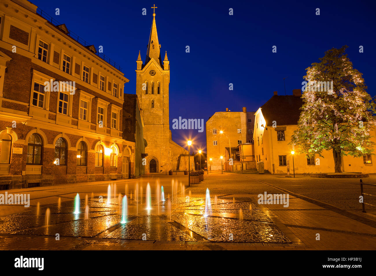 Medieval church of Saint John and night old town view of Cesis, Latvia ...