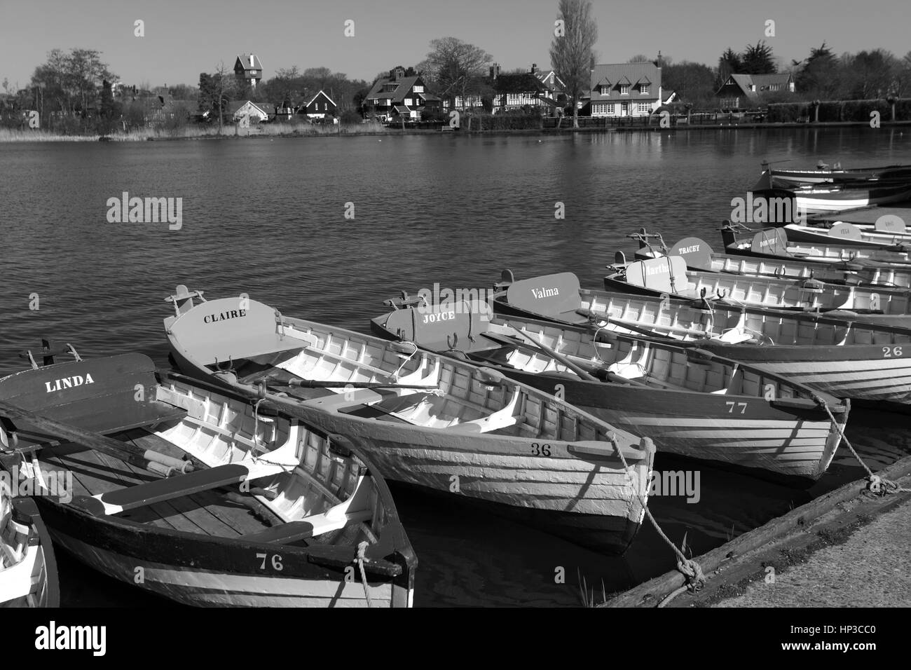 Colourful wooden rowing boats for hire on the Mere at Thorpeness ...