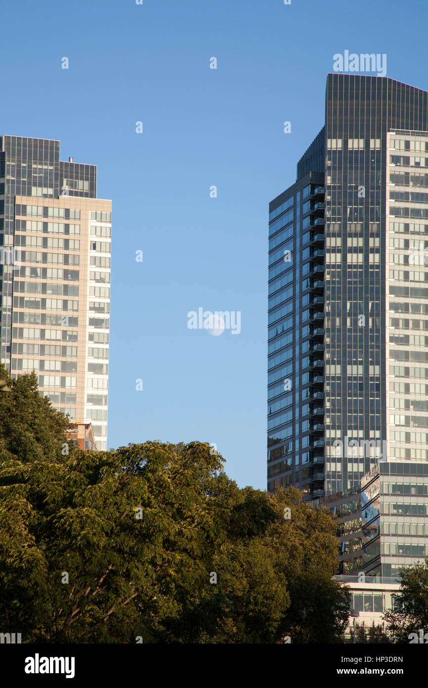 The moon seen between office and apartment buildings from Boston Common ...