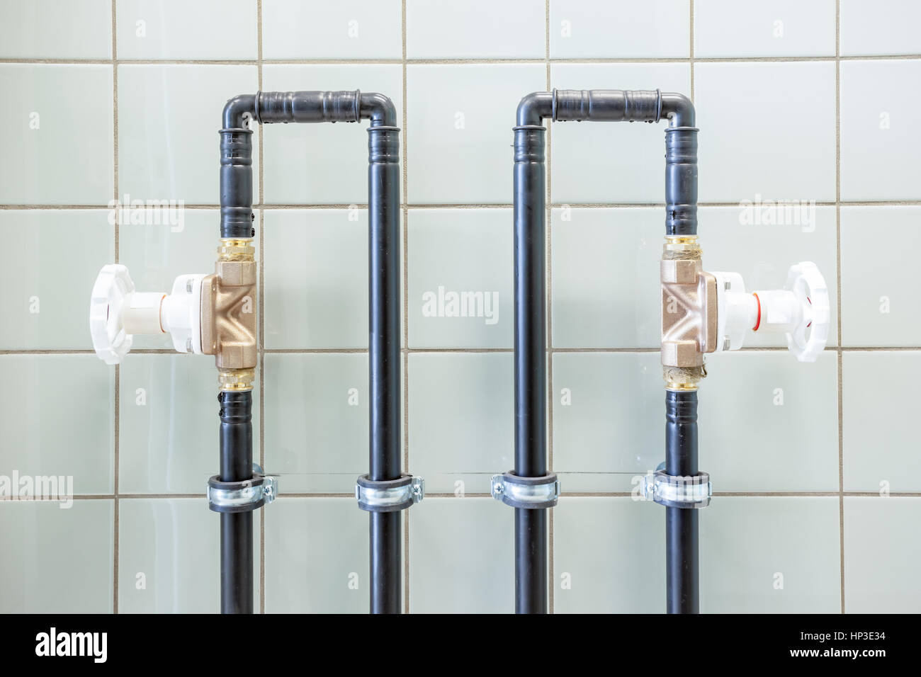water pipes with valves on the wall Stock Photo - Alamy