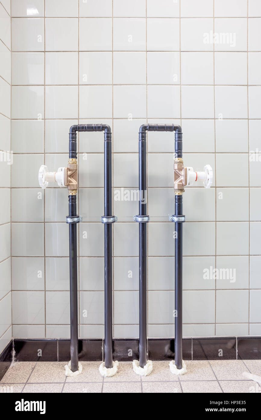 water pipes with valves on the wall Stock Photo - Alamy
