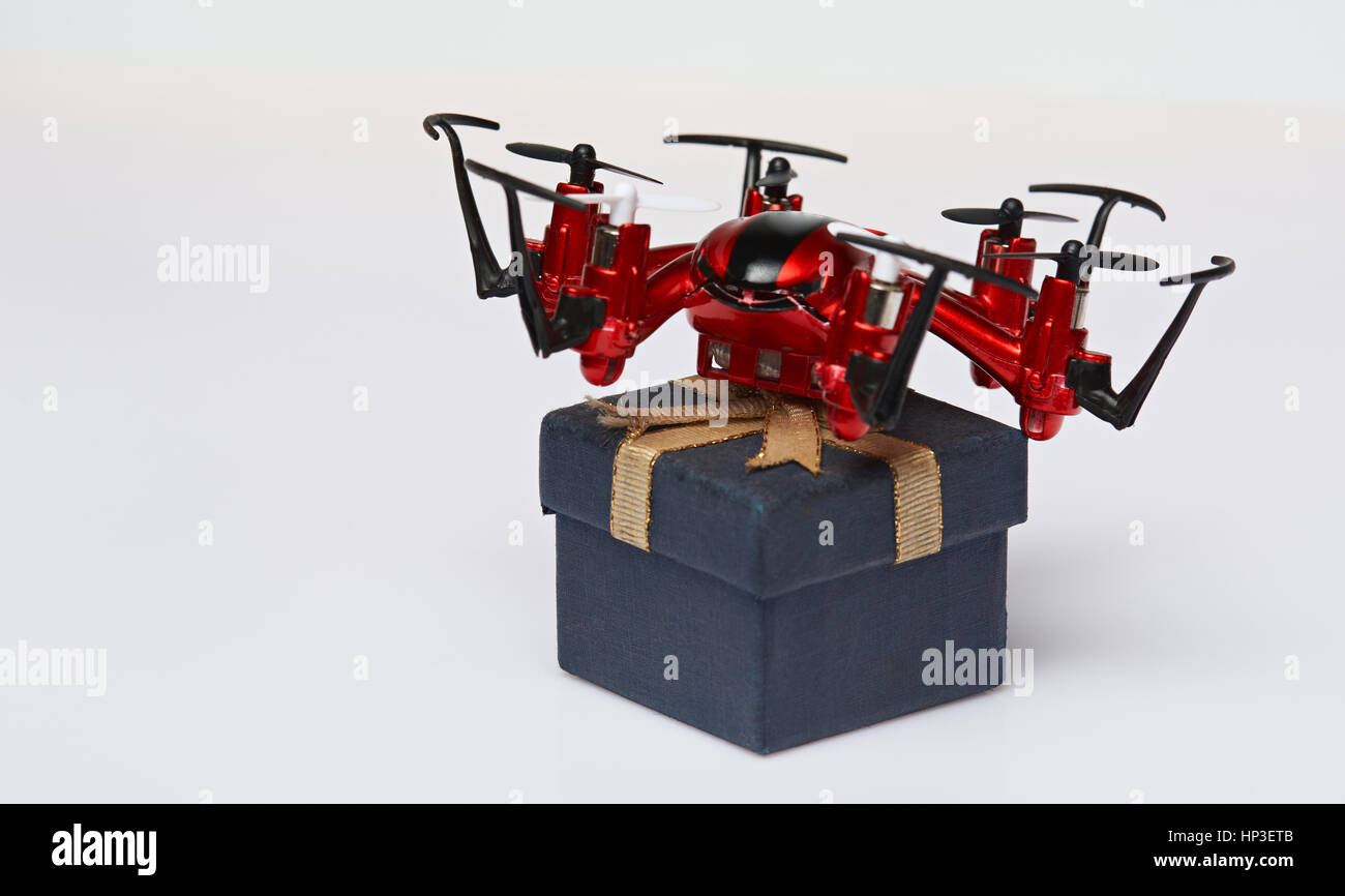 Drone with gift box isolated on white background. Shipping fly drone ...