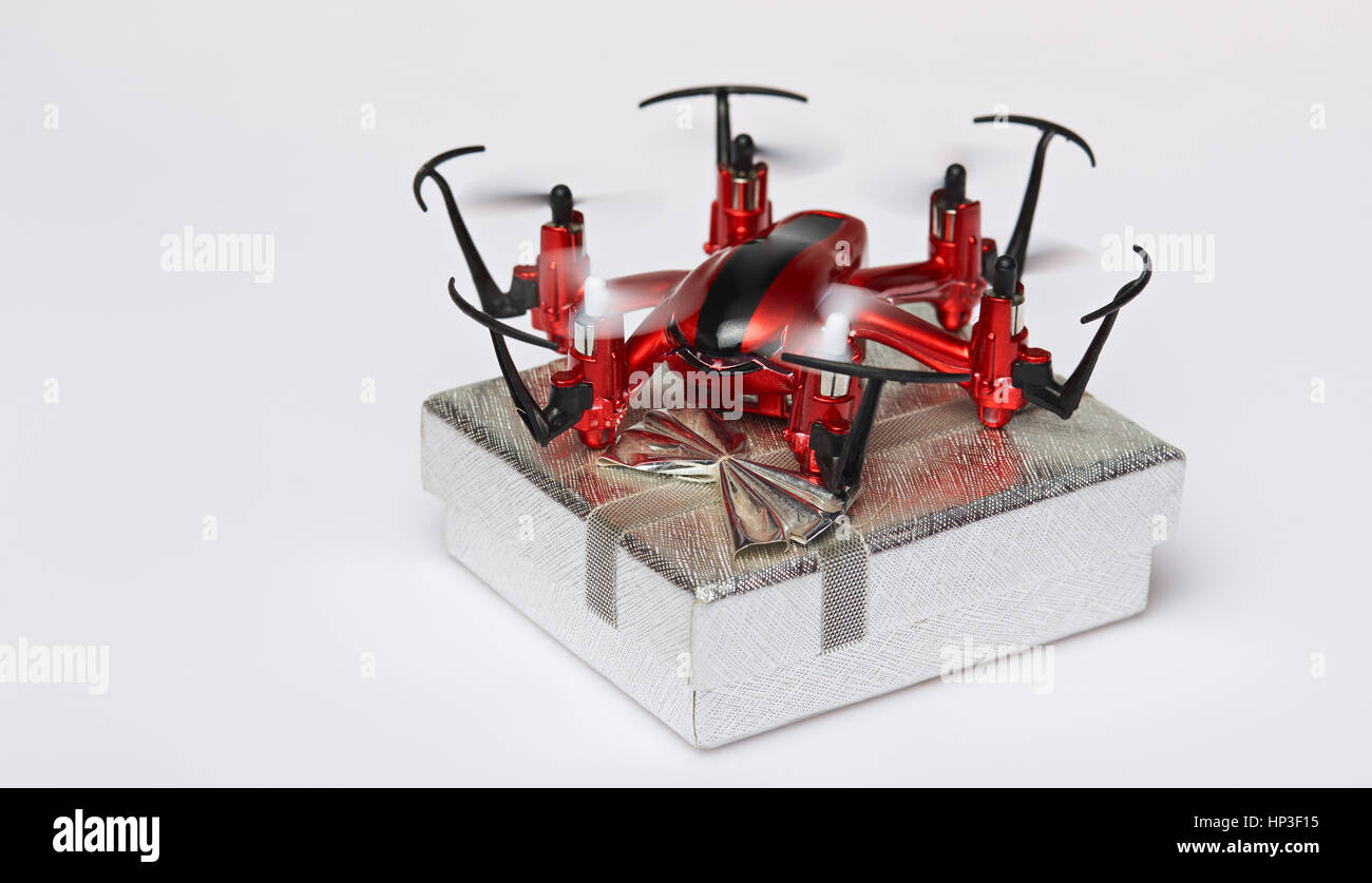 Drone carrying gift box isolated on white background. Present via fast ...