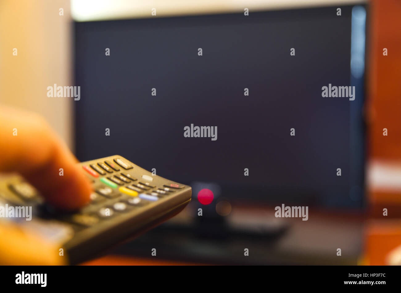 Man holding remote control for smart TV Stock Photo - Alamy