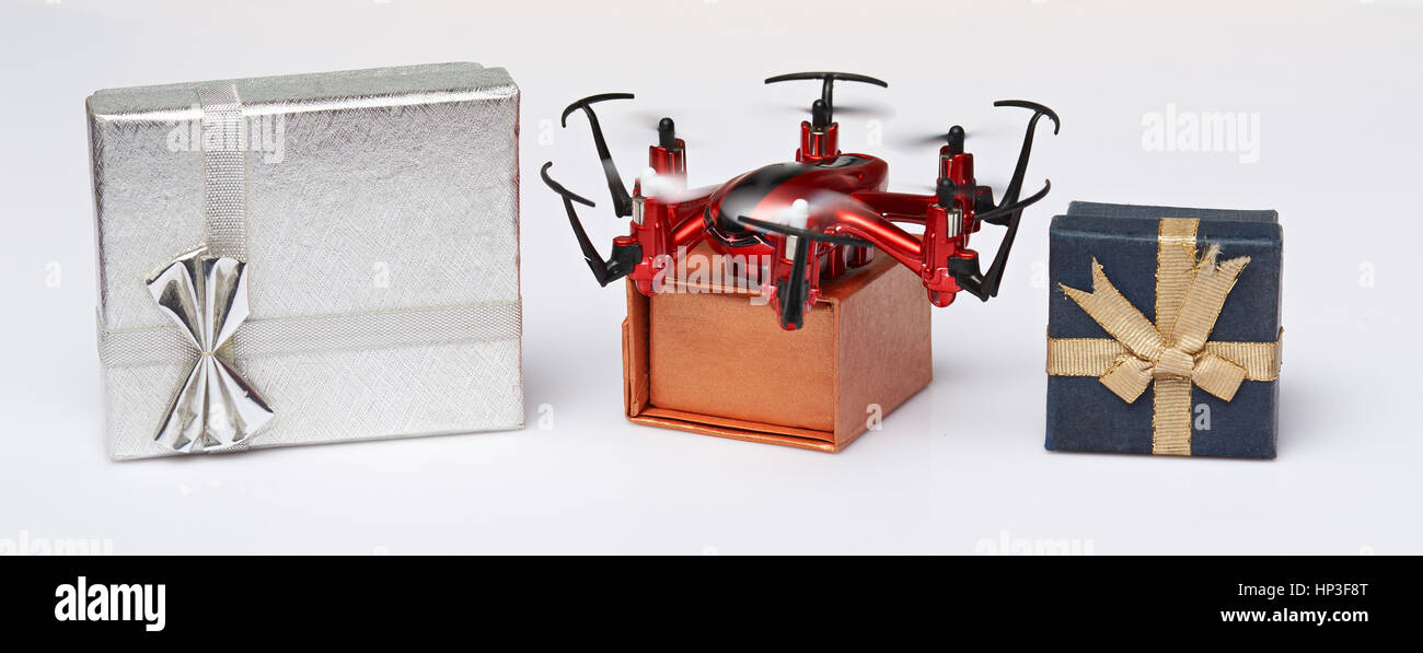 Express delivery via drone service. Gift boxes transport by drone ...