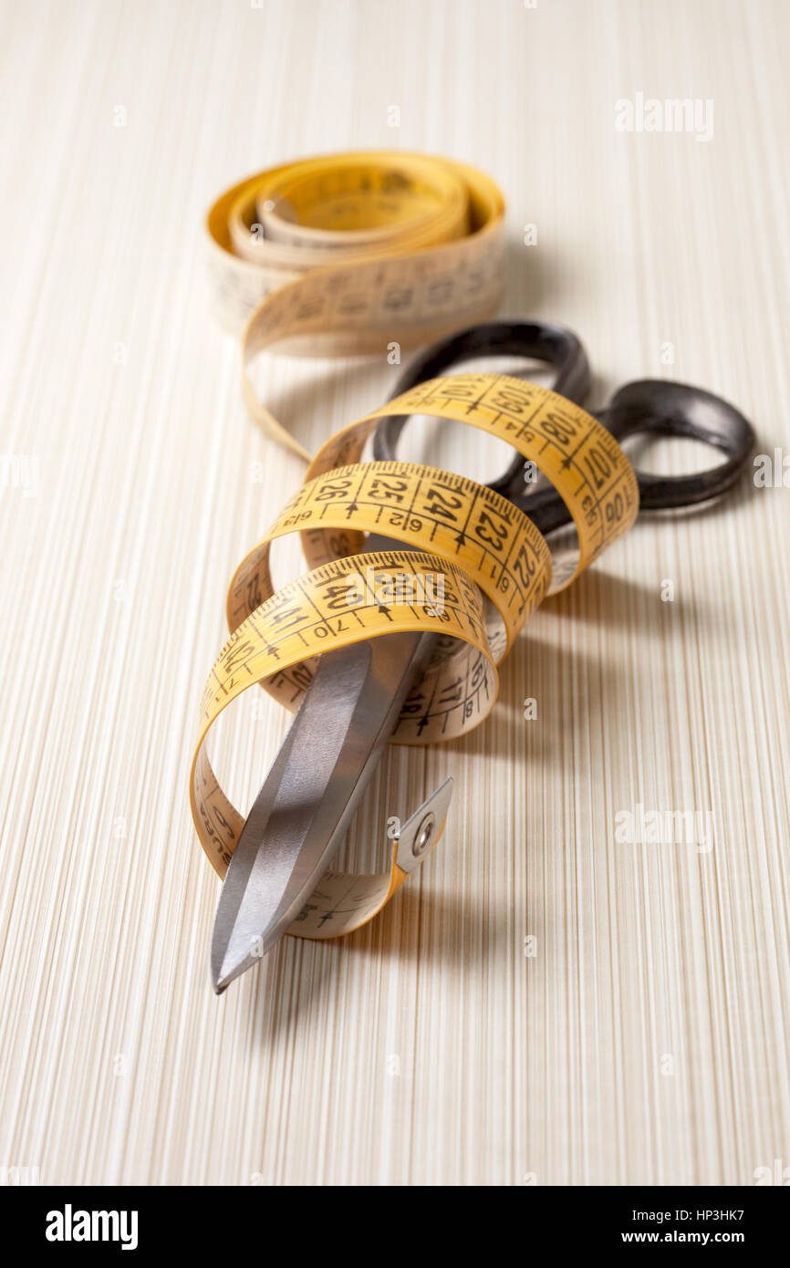 background with tools for sewing: scissors and tape measure Stock Photo ...
