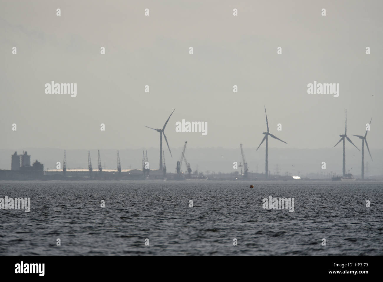 The cranes of Sheerness Port in Kent with the Sheerness Wind Farm ...