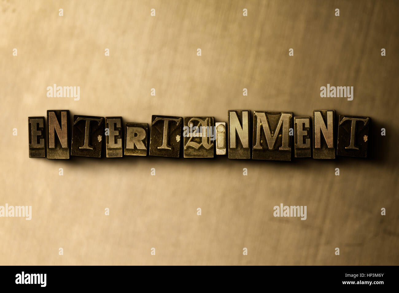 ENTERTAINMENT - close-up of grungy vintage typeset word on metal ...