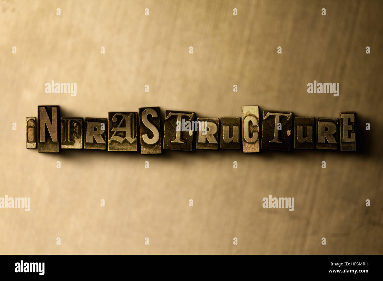 INFRASTRUCTURE - close-up of grungy vintage typeset word on metal ...