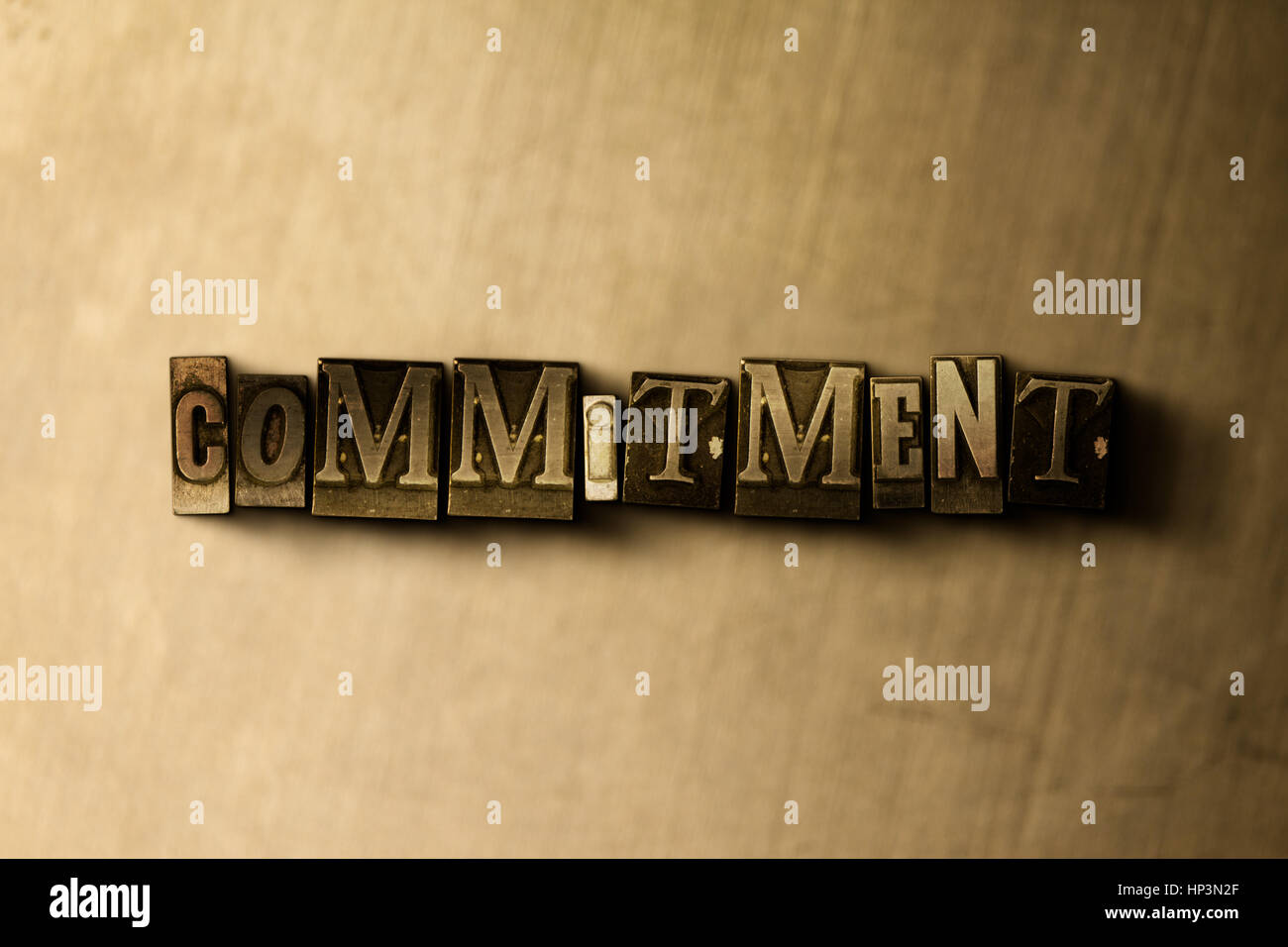 COMMITMENT - close-up of grungy vintage typeset word on metal backdrop ...