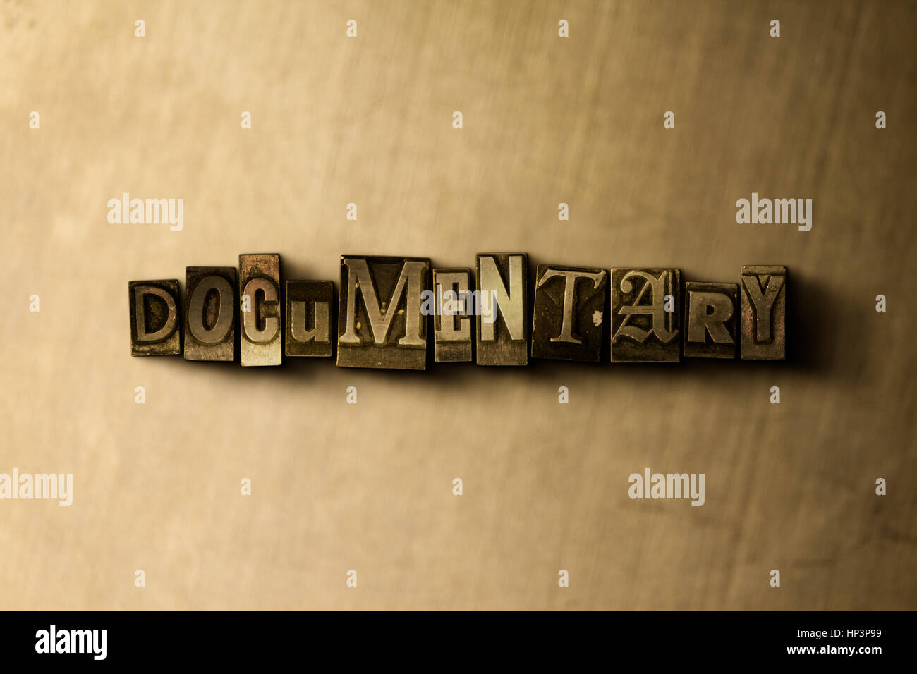 DOCUMENTARY - close-up of grungy vintage typeset word on metal backdrop ...