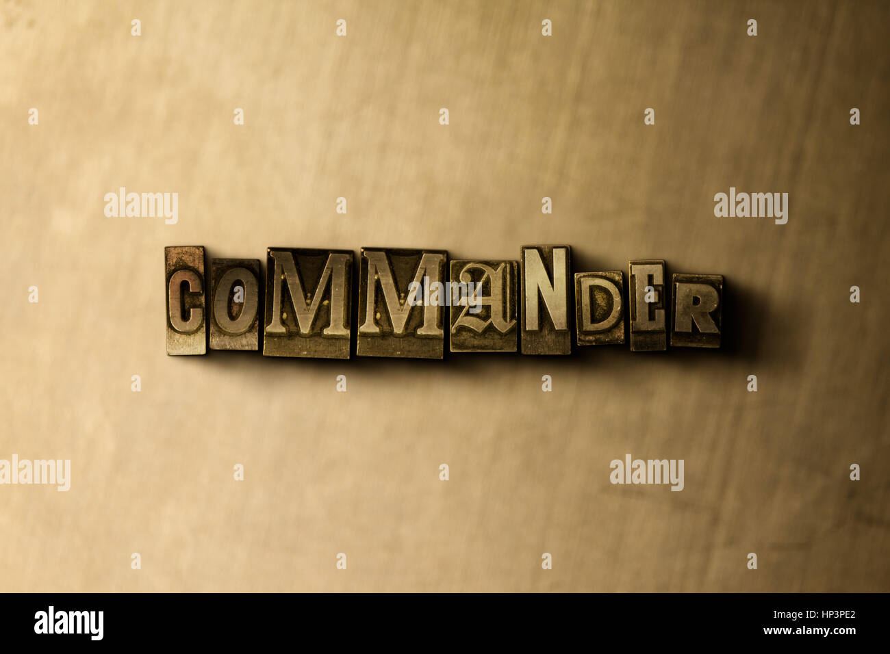 COMMANDER - close-up of grungy vintage typeset word on metal backdrop ...