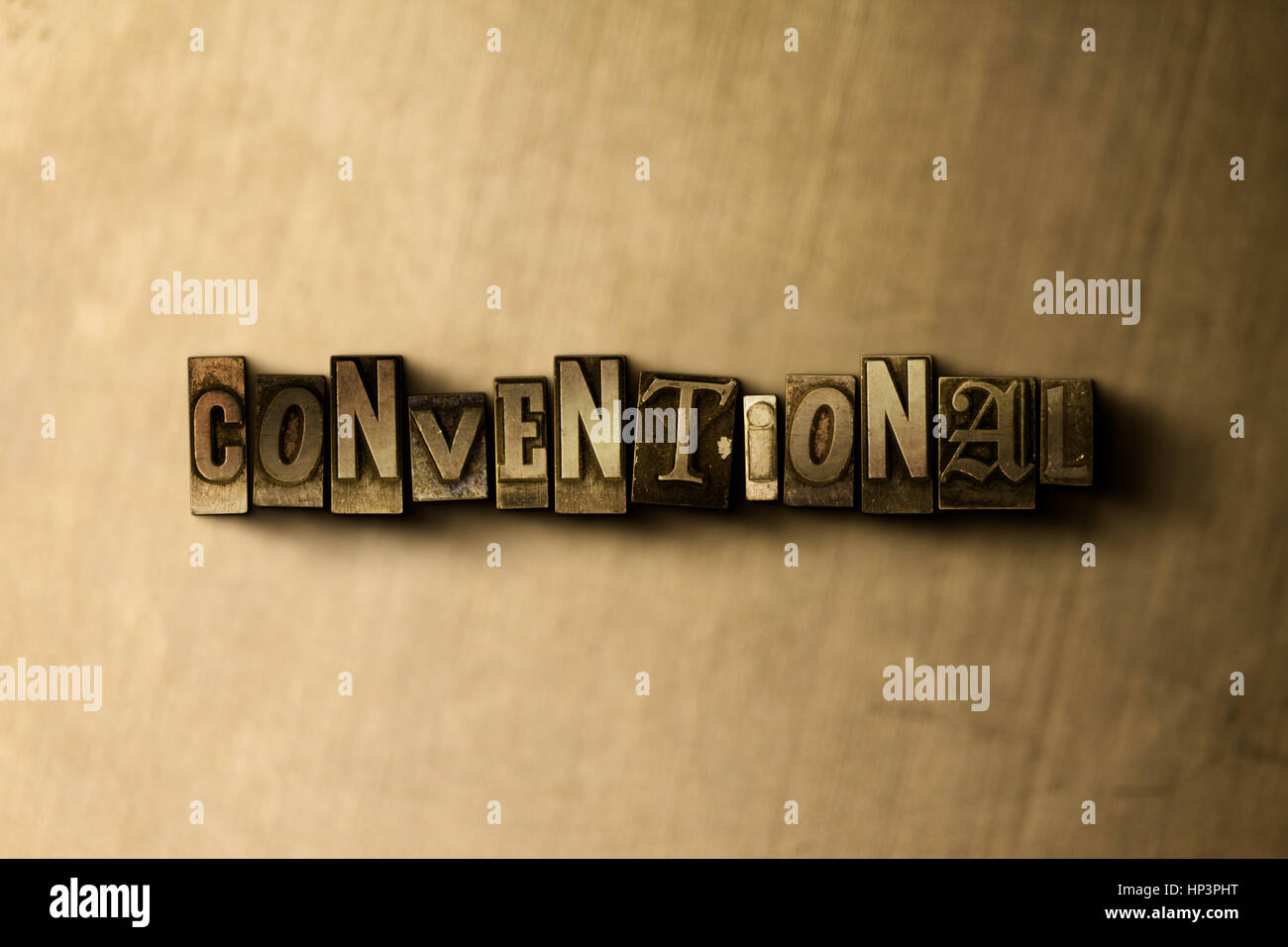 CONVENTIONAL - close-up of grungy vintage typeset word on metal ...
