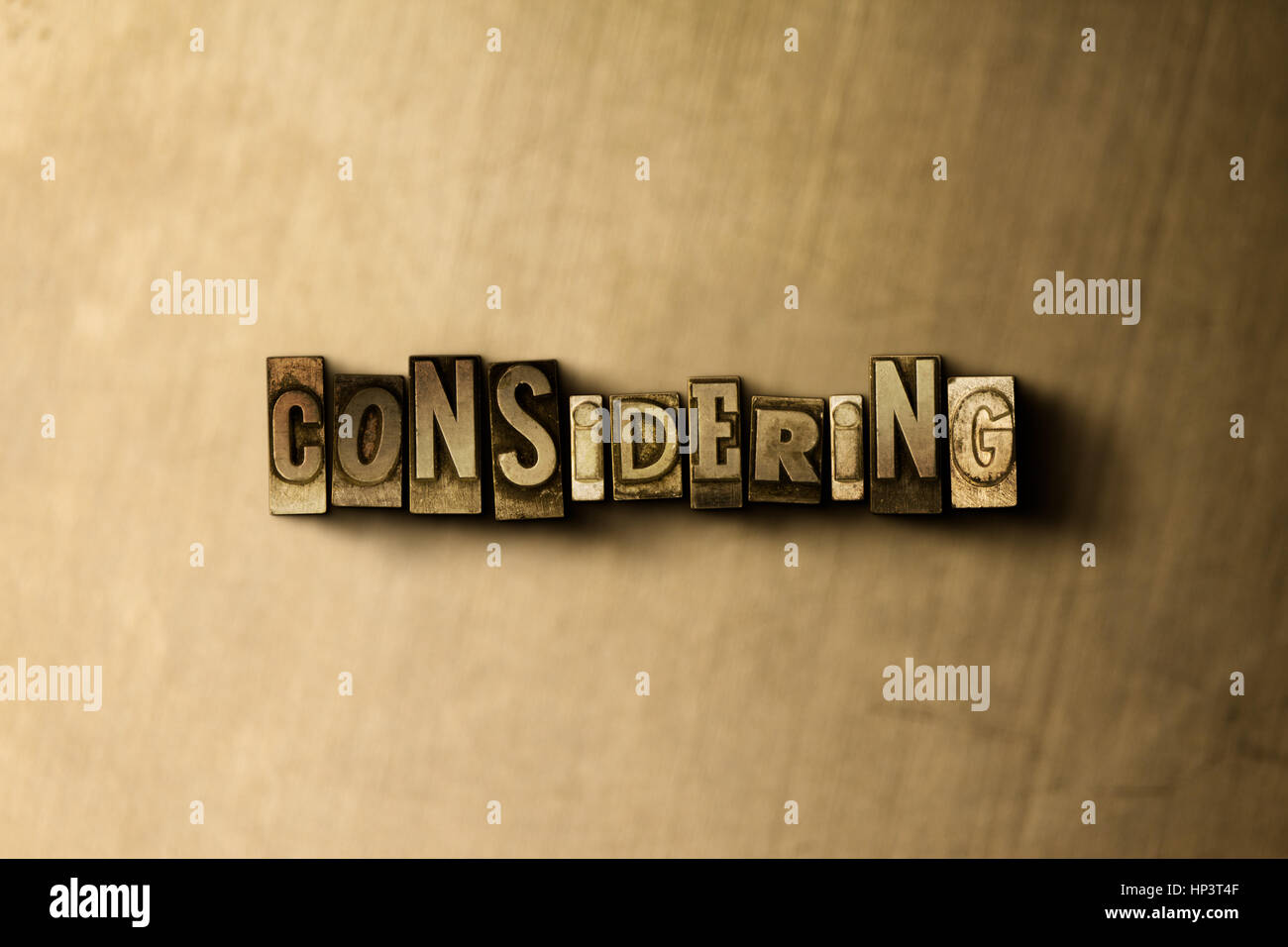 CONSIDERING - close-up of grungy vintage typeset word on metal backdrop ...