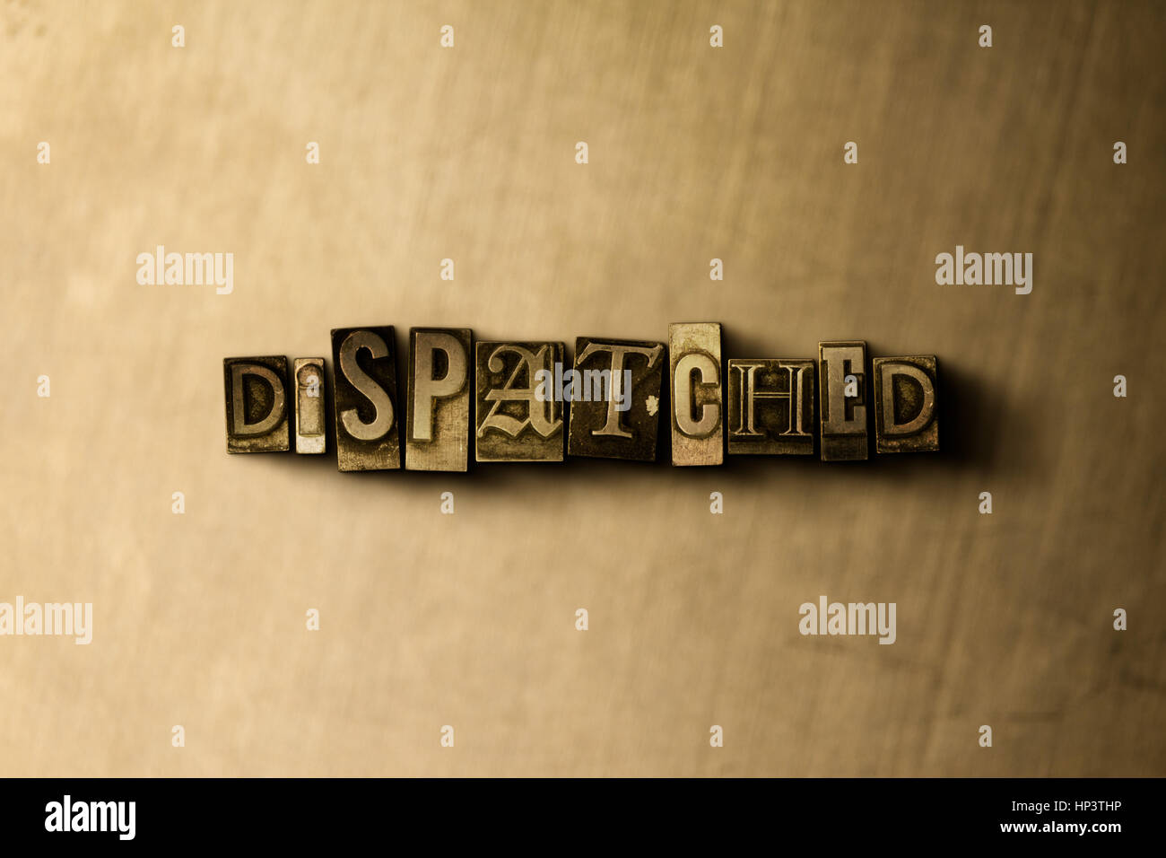 DISPATCHED - close-up of grungy vintage typeset word on metal backdrop ...