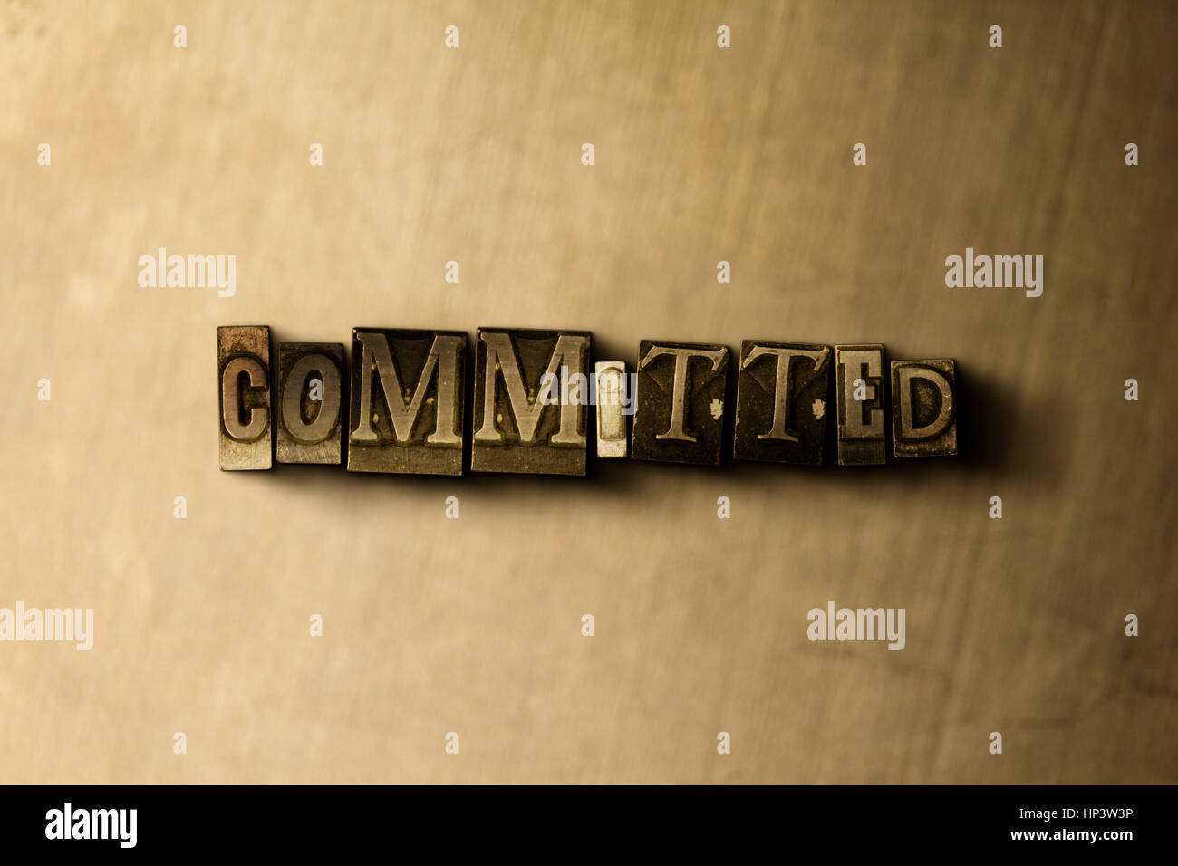 COMMITTED - close-up of grungy vintage typeset word on metal backdrop ...