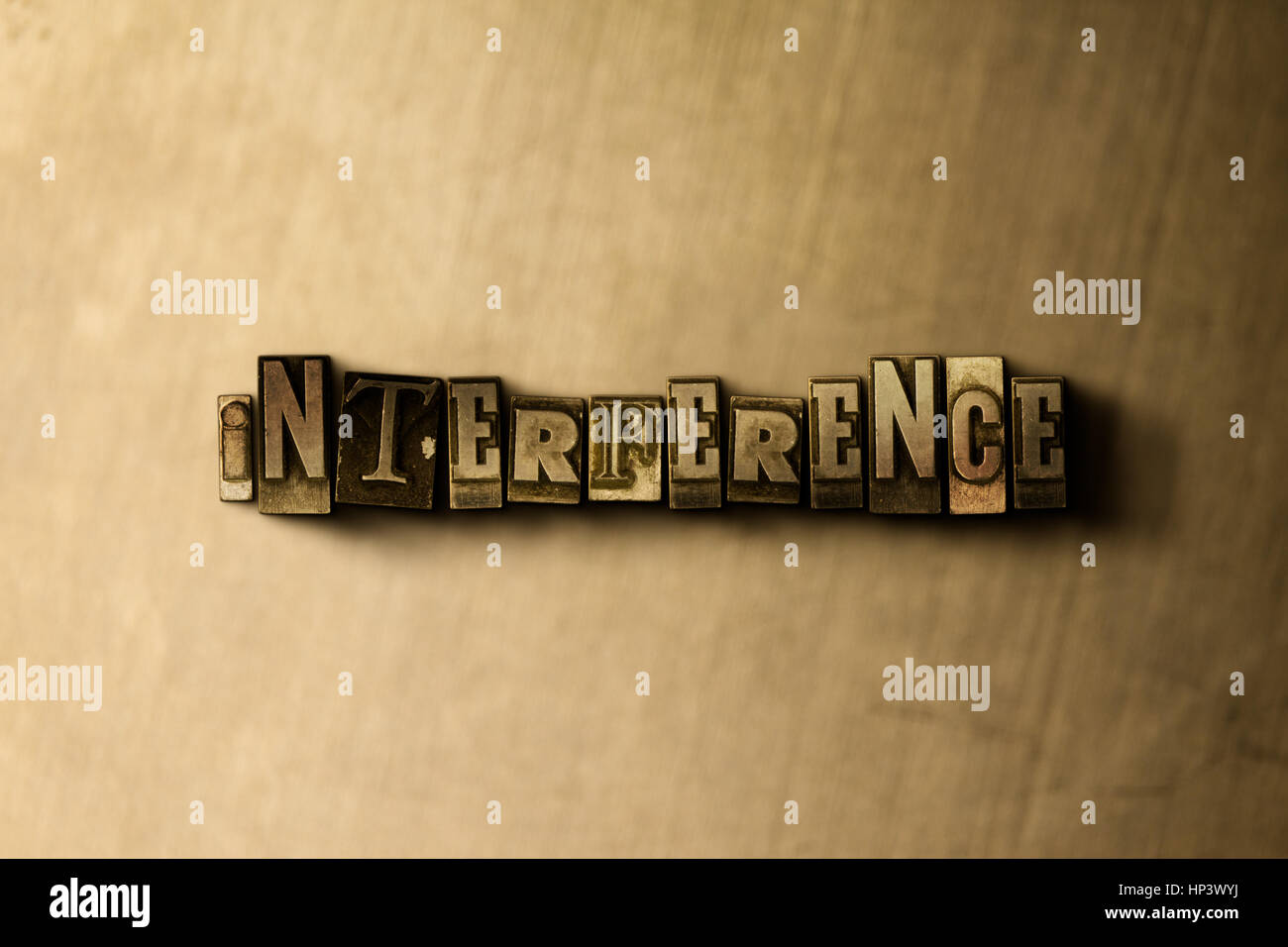 INTERFERENCE - close-up of grungy vintage typeset word on metal ...