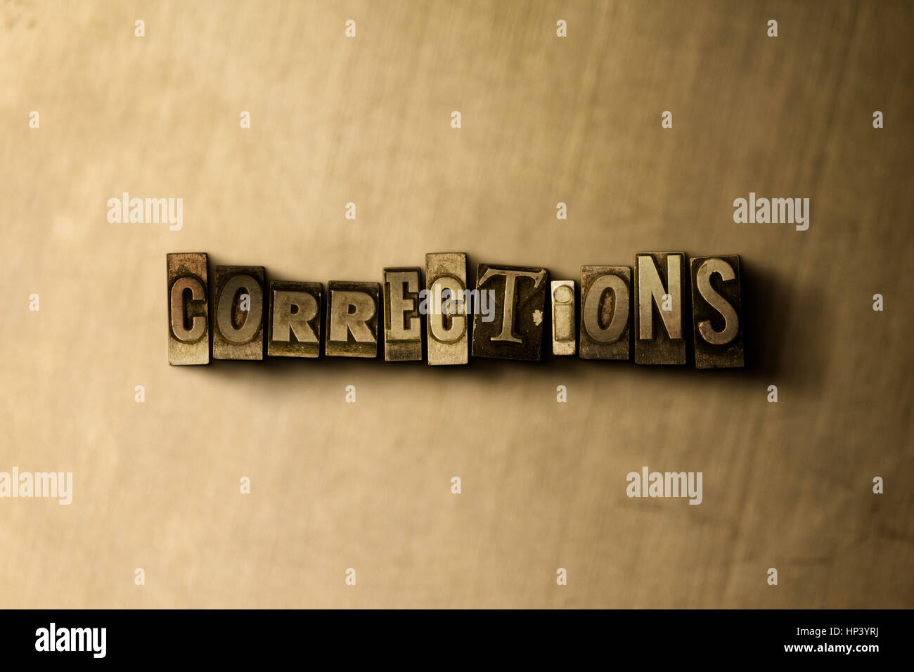 CORRECTIONS - close-up of grungy vintage typeset word on metal backdrop ...