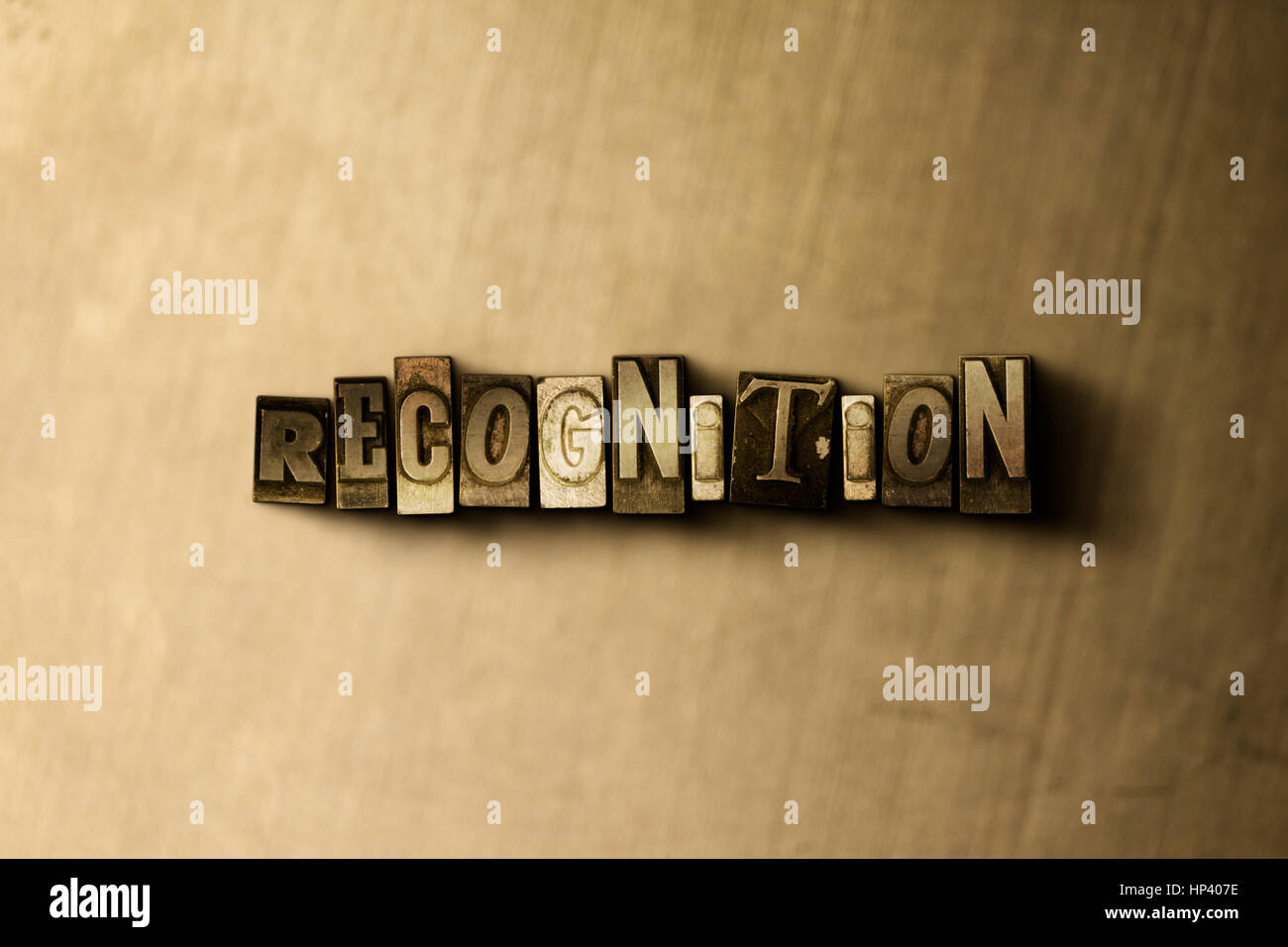 RECOGNITION - close-up of grungy vintage typeset word on metal backdrop ...