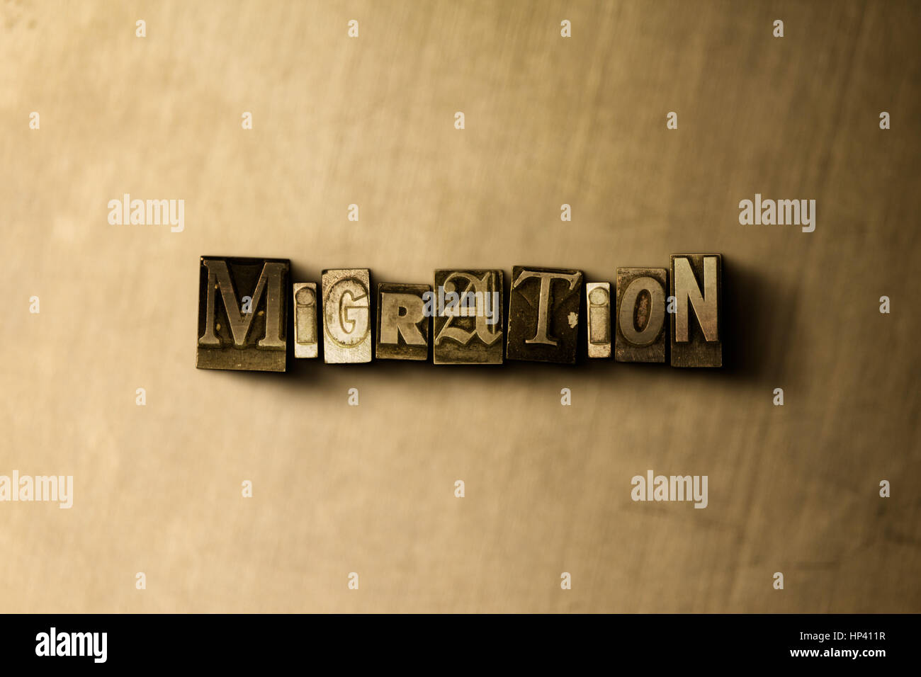MIGRATION - close-up of grungy vintage typeset word on metal backdrop ...