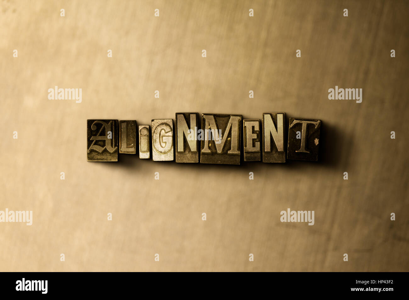 ALIGNMENT - close-up of grungy vintage typeset word on metal backdrop ...