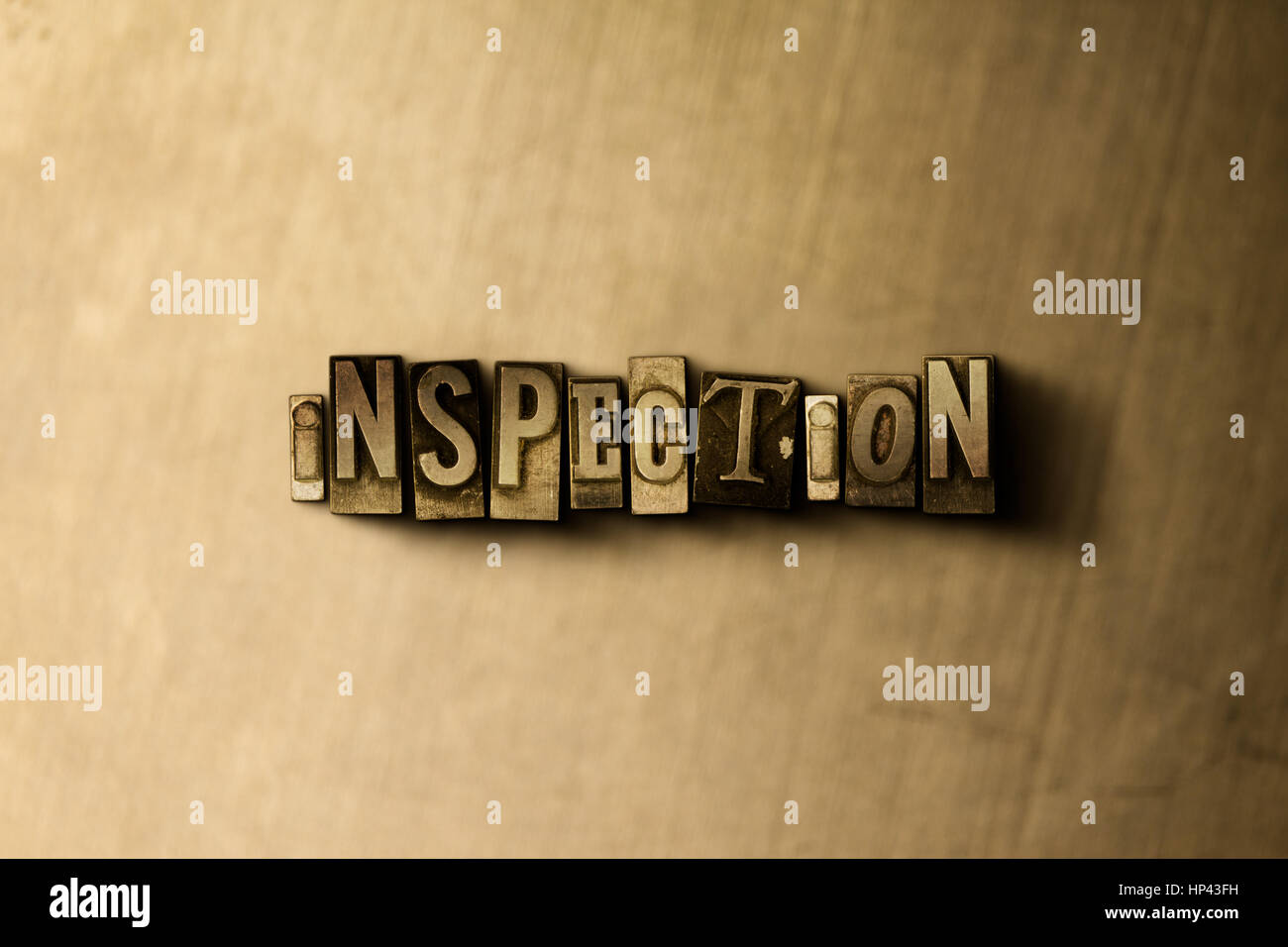 INSPECTION - close-up of grungy vintage typeset word on metal backdrop ...